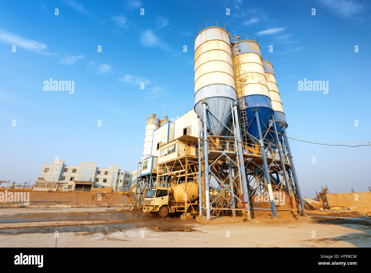 Small cement factory under blue sky Stock Photo - Alamy