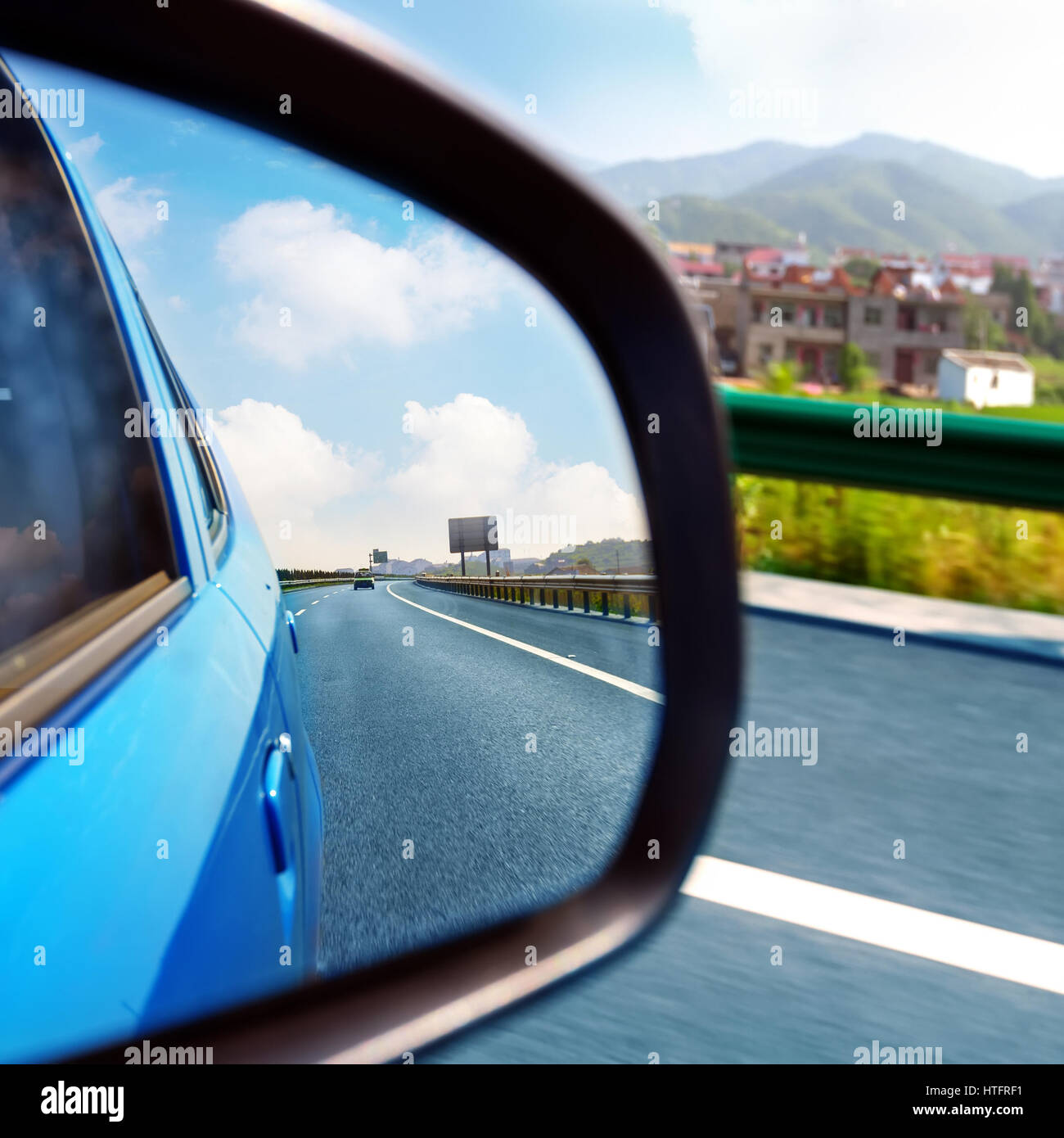 From the inside rearview mirror to see the highway and cars Stock Photo ...