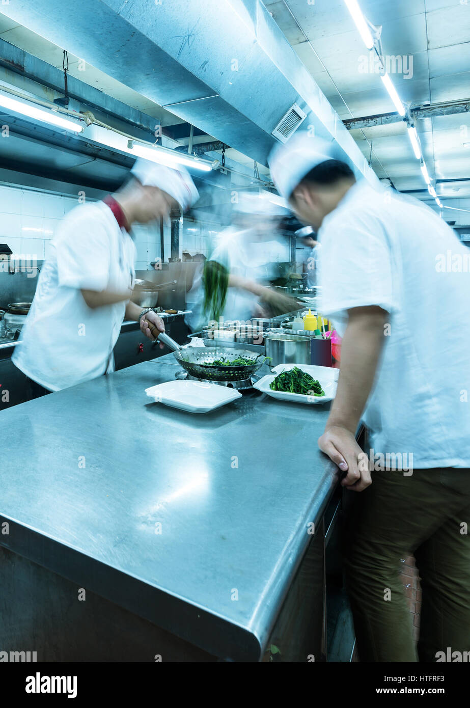Crowded kitchen, a narrow aisle, working chef Stock Photo - Alamy