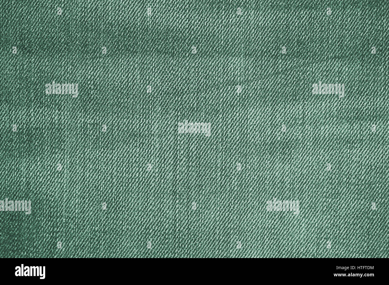 Green texture of jeans textile close up. Blank backdrop for design ...