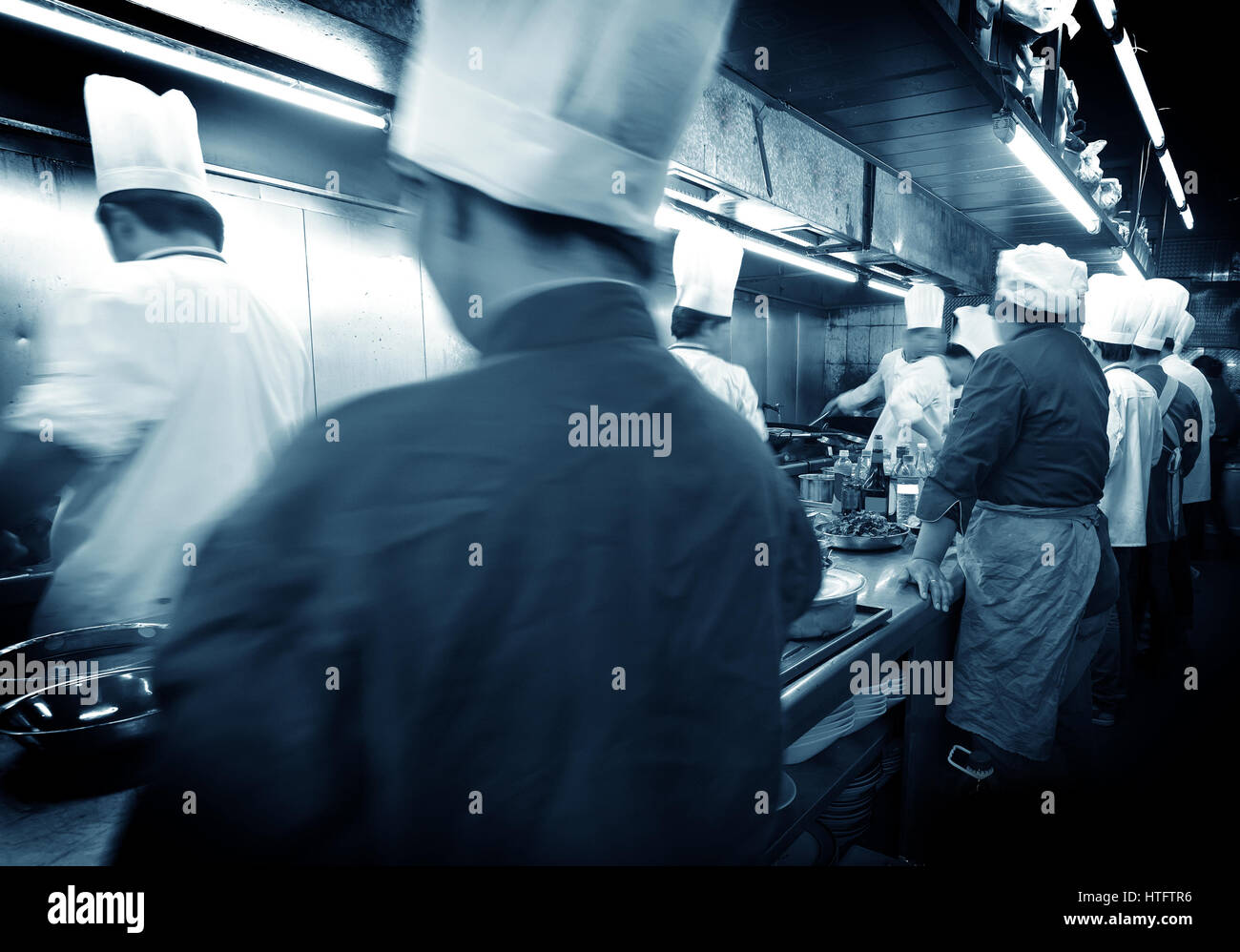 Crowded kitchen, a narrow aisle, working chef Stock Photo - Alamy