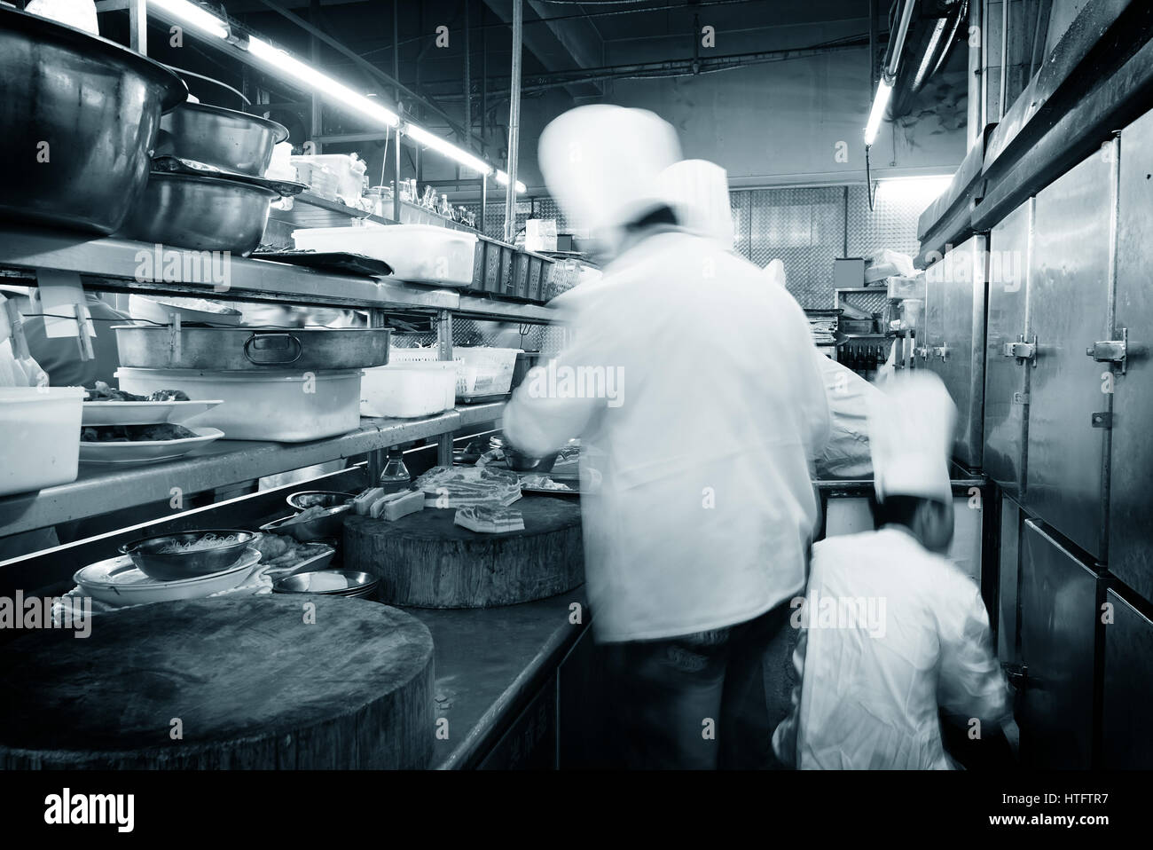 Crowded kitchen, a narrow aisle, working chef Stock Photo - Alamy