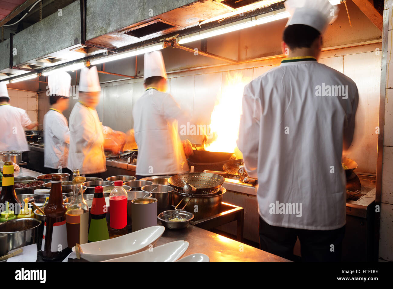 Crowded kitchen, a narrow aisle, working chef Stock Photo - Alamy