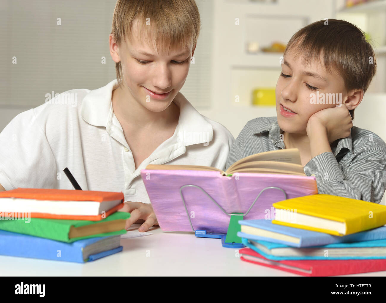 Portrait of two boys with their homework Stock Photo - Alamy