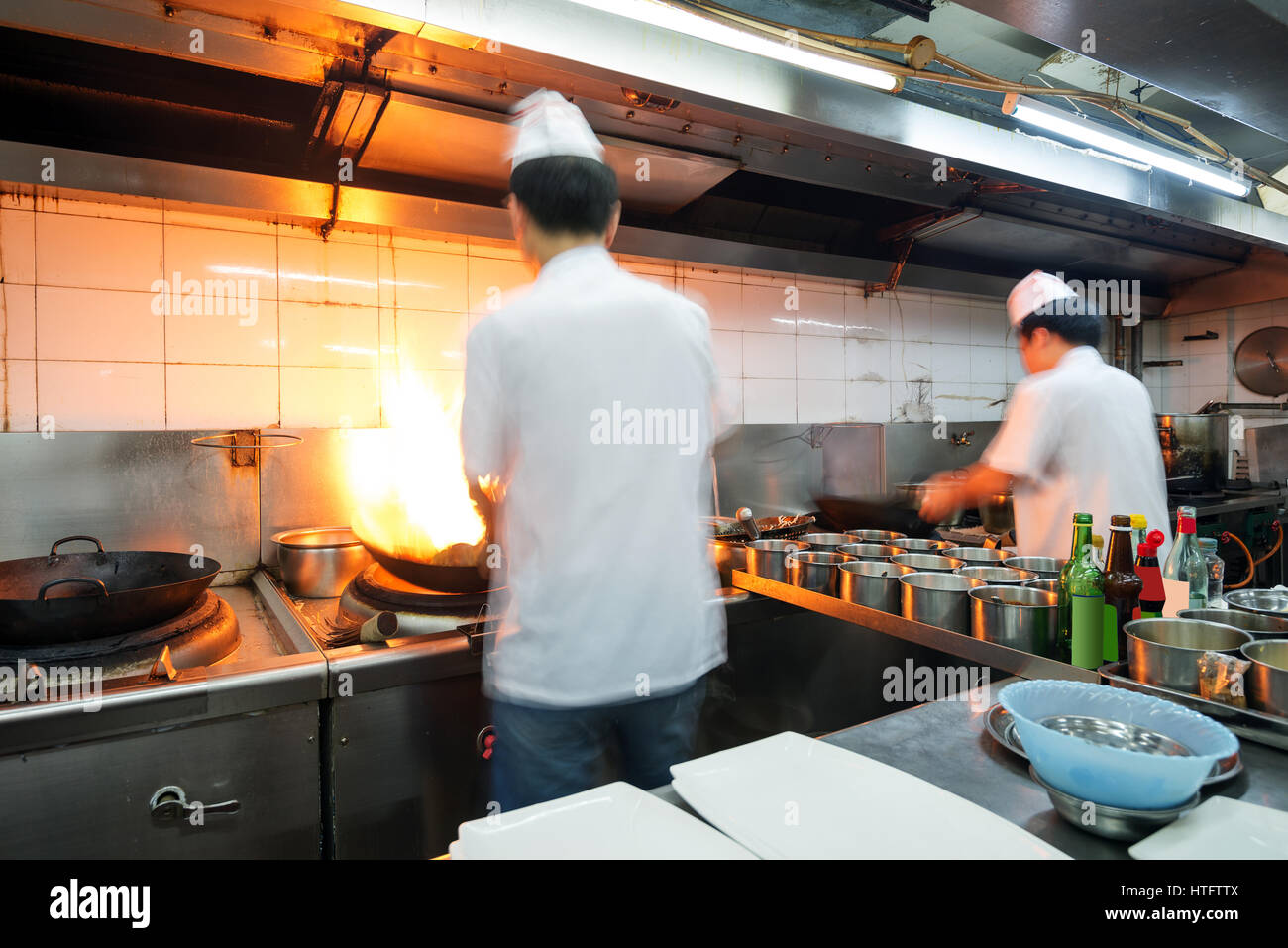 Crowded kitchen, a narrow aisle, working chef Stock Photo - Alamy