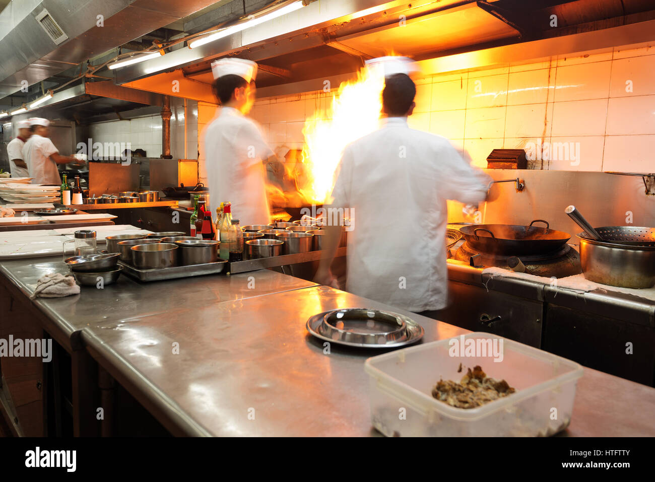 Crowded kitchen, a narrow aisle, working chef Stock Photo - Alamy