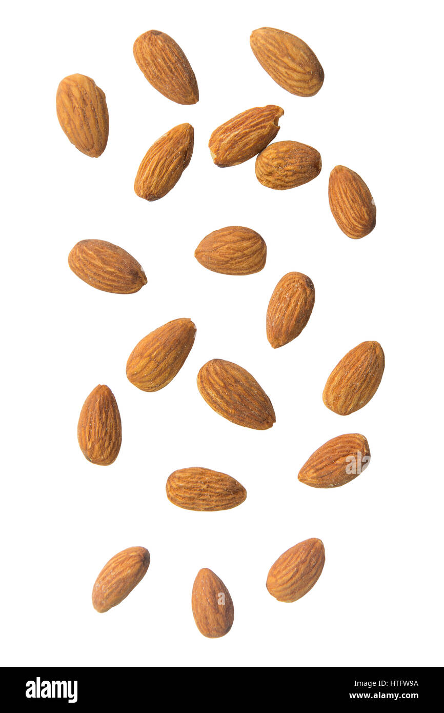 Falling almonds on white background Stock Photo - Alamy