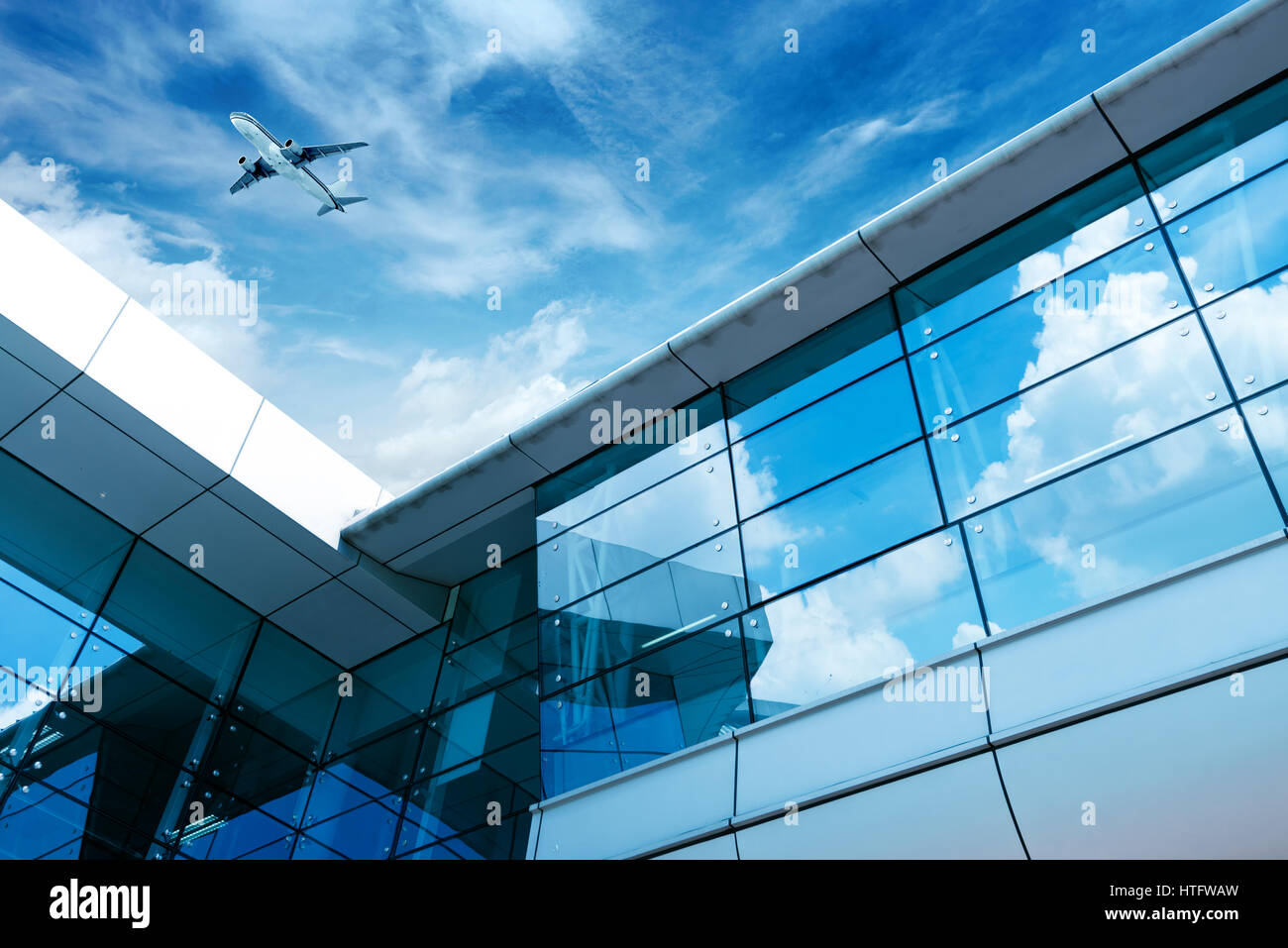 glass curtain wall and aircraft against a blue sky Stock Photo - Alamy