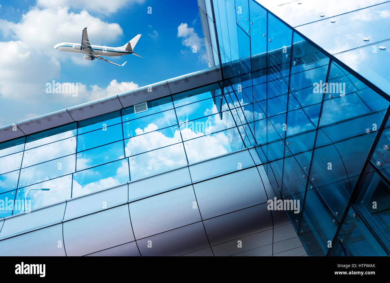 glass curtain wall and aircraft against a blue sky Stock Photo - Alamy