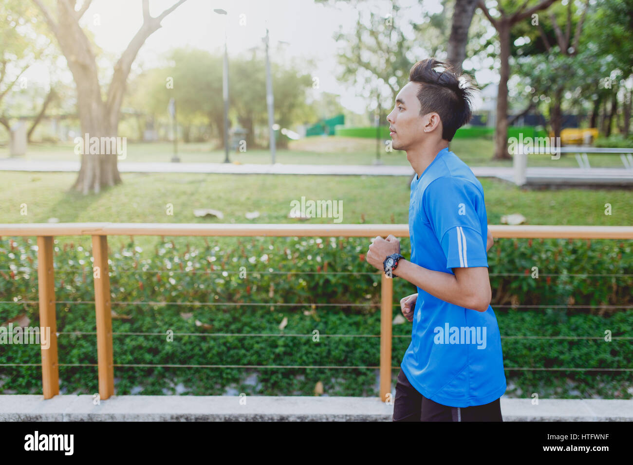 Running man. Male runner jogging during outdoor workout at public park ...