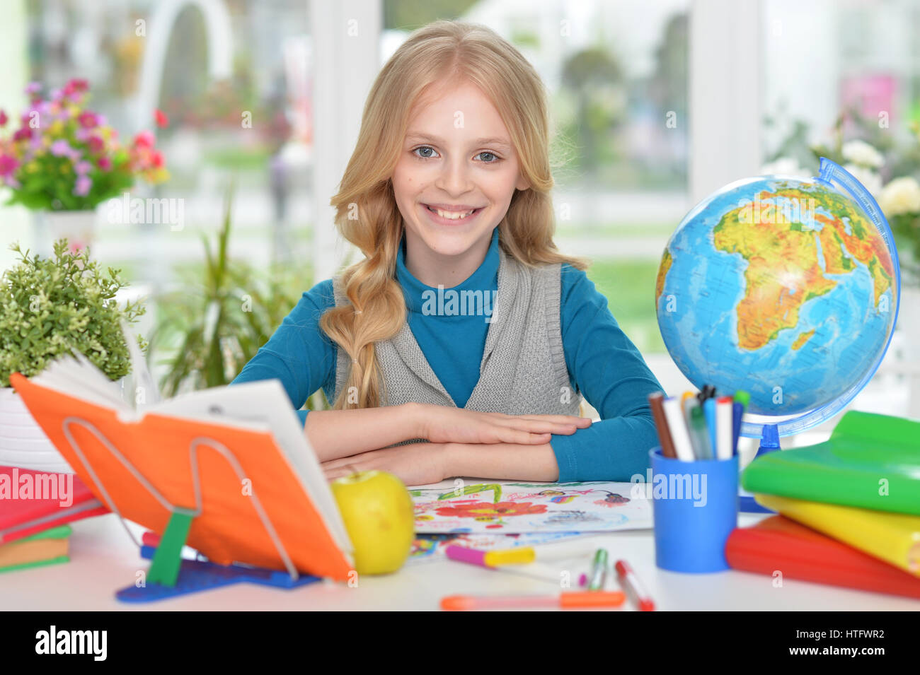 Portrait of a cute girl does lessons Stock Photo - Alamy