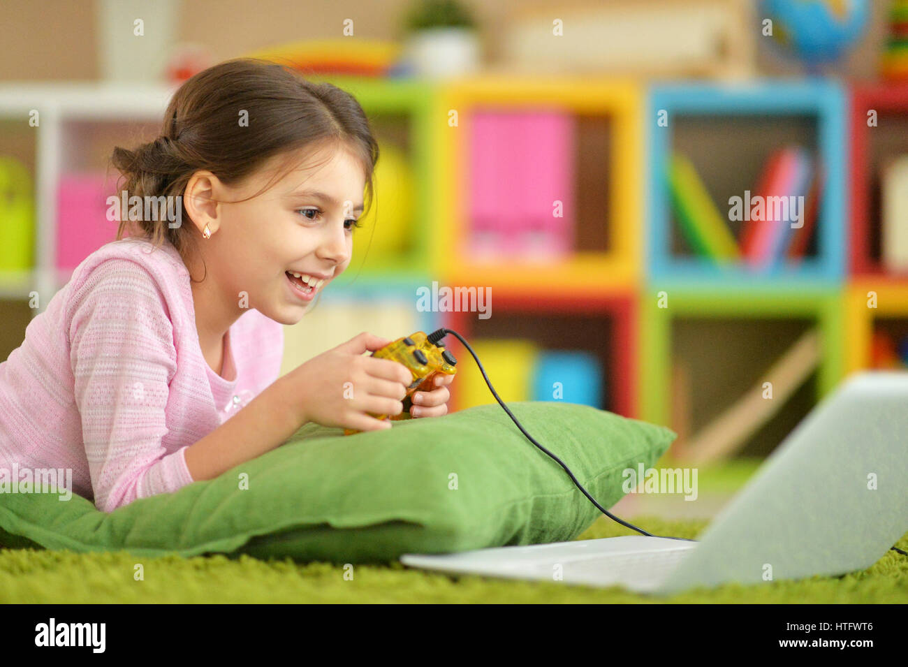 Little girl is playing a computer game Stock Photo - Alamy