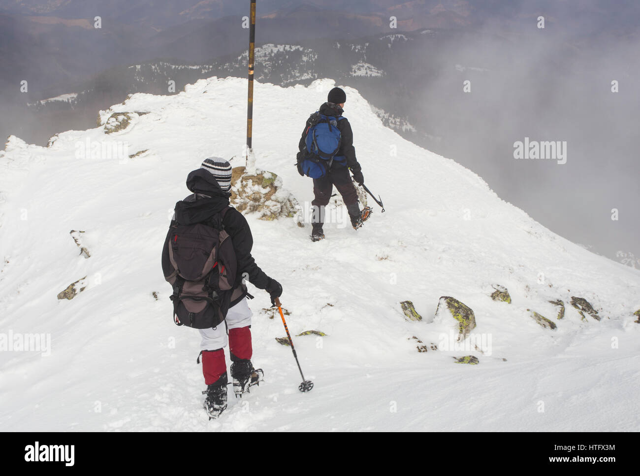 Tourists in a winter mountain Stock Photo - Alamy