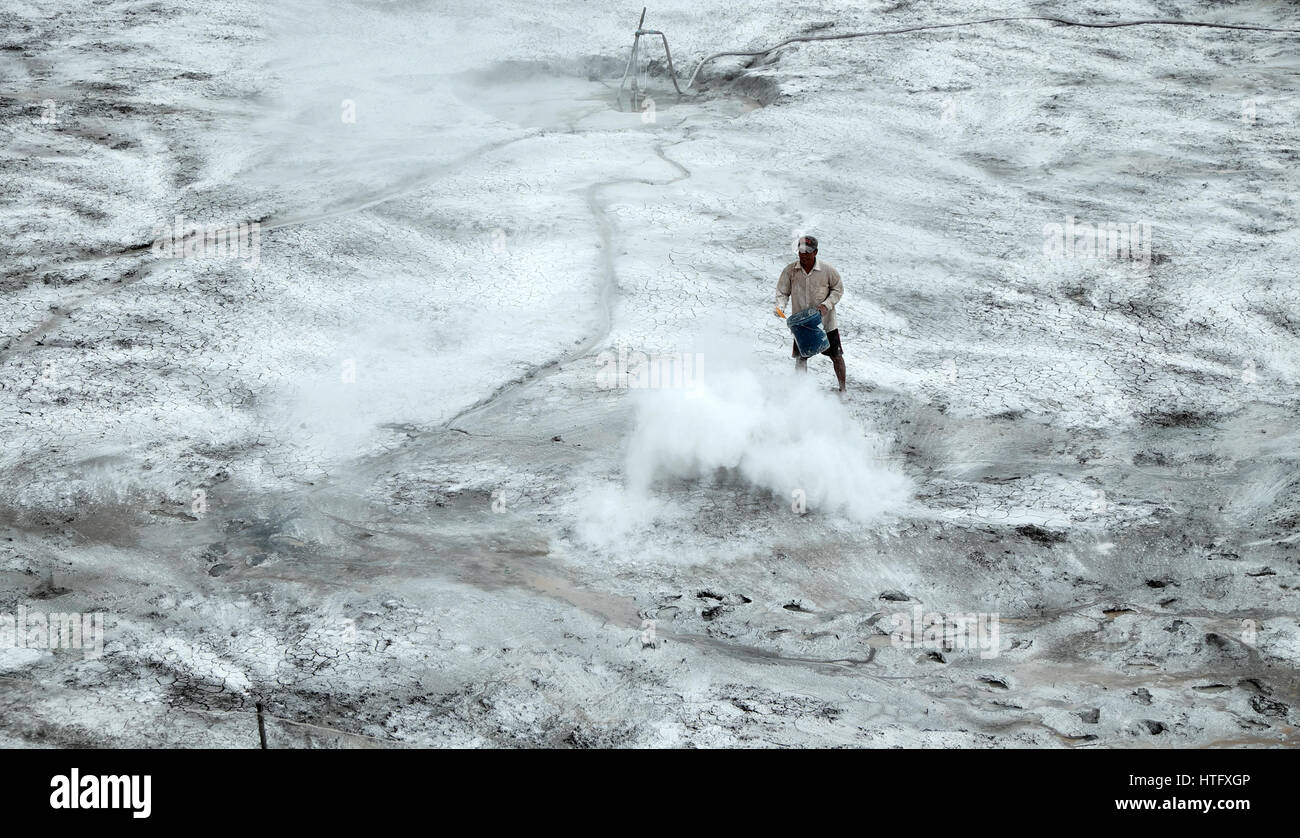 Asian farmer spreading lime powder, antiseptic for shrimp pond, man ...