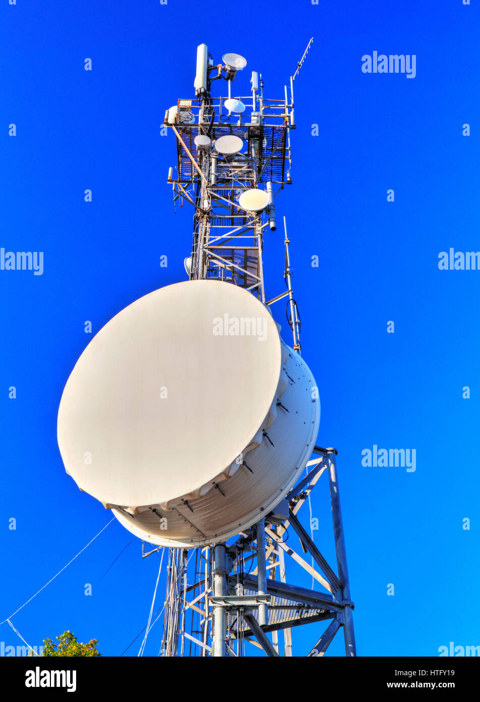 Communication antenna tower on blue sky Stock Photo - Alamy