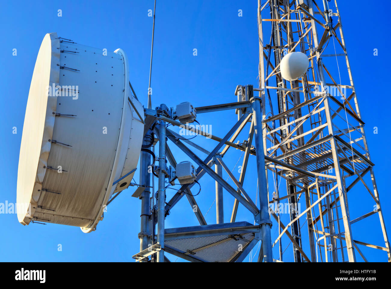 Communication antenna tower on blue sky Stock Photo - Alamy