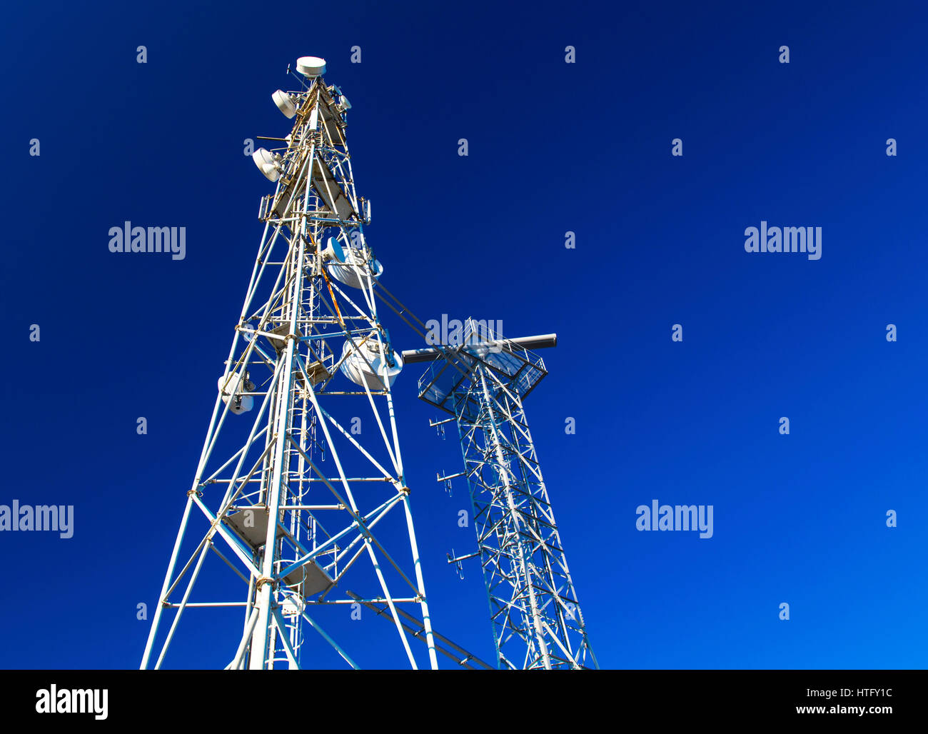 Communication antenna tower on blue sky Stock Photo - Alamy
