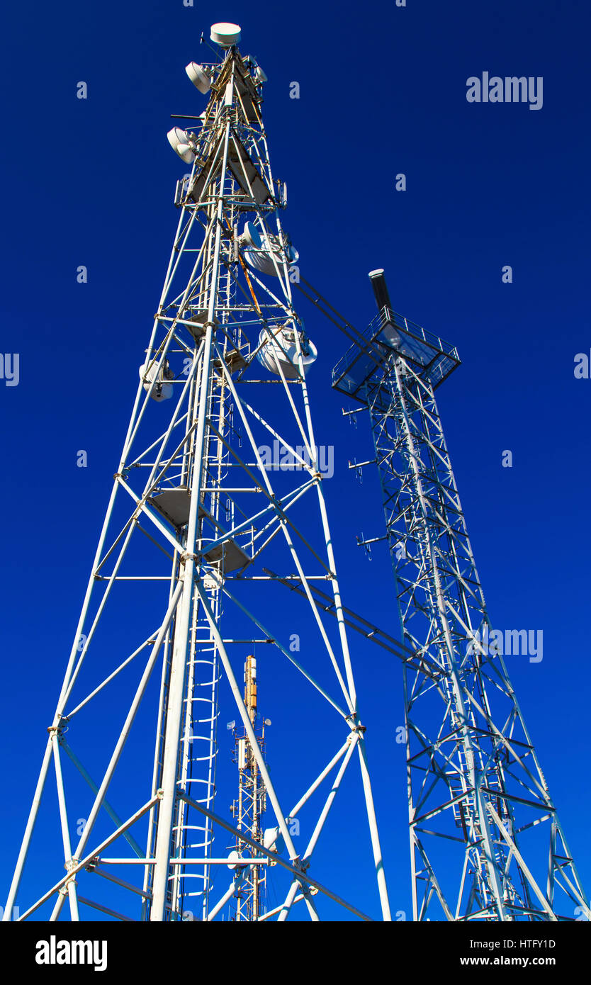Communication antenna tower on blue sky Stock Photo - Alamy