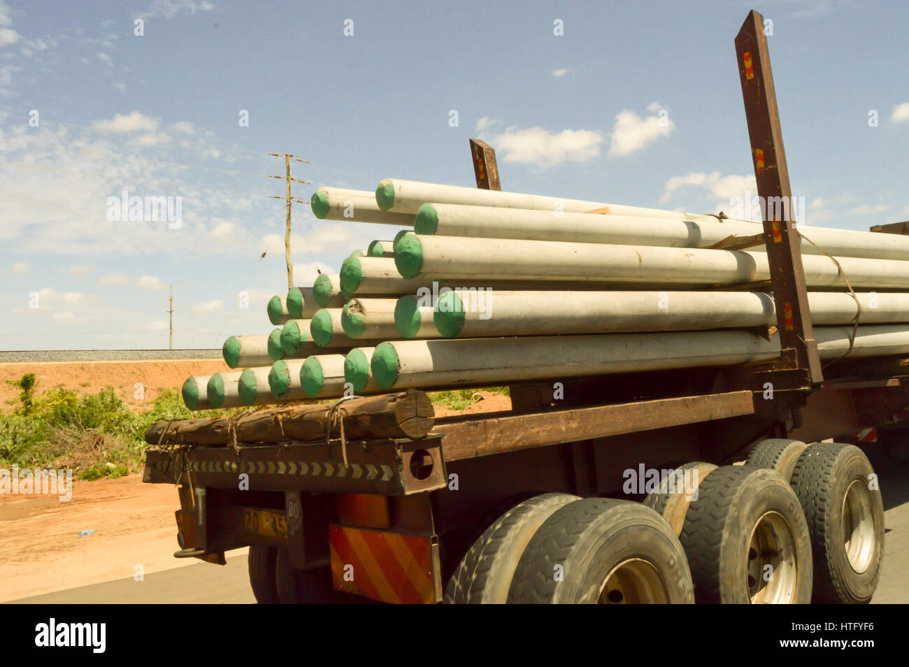 Wooden pylons lighting on a trailer of a truck on the road from mombasa ...