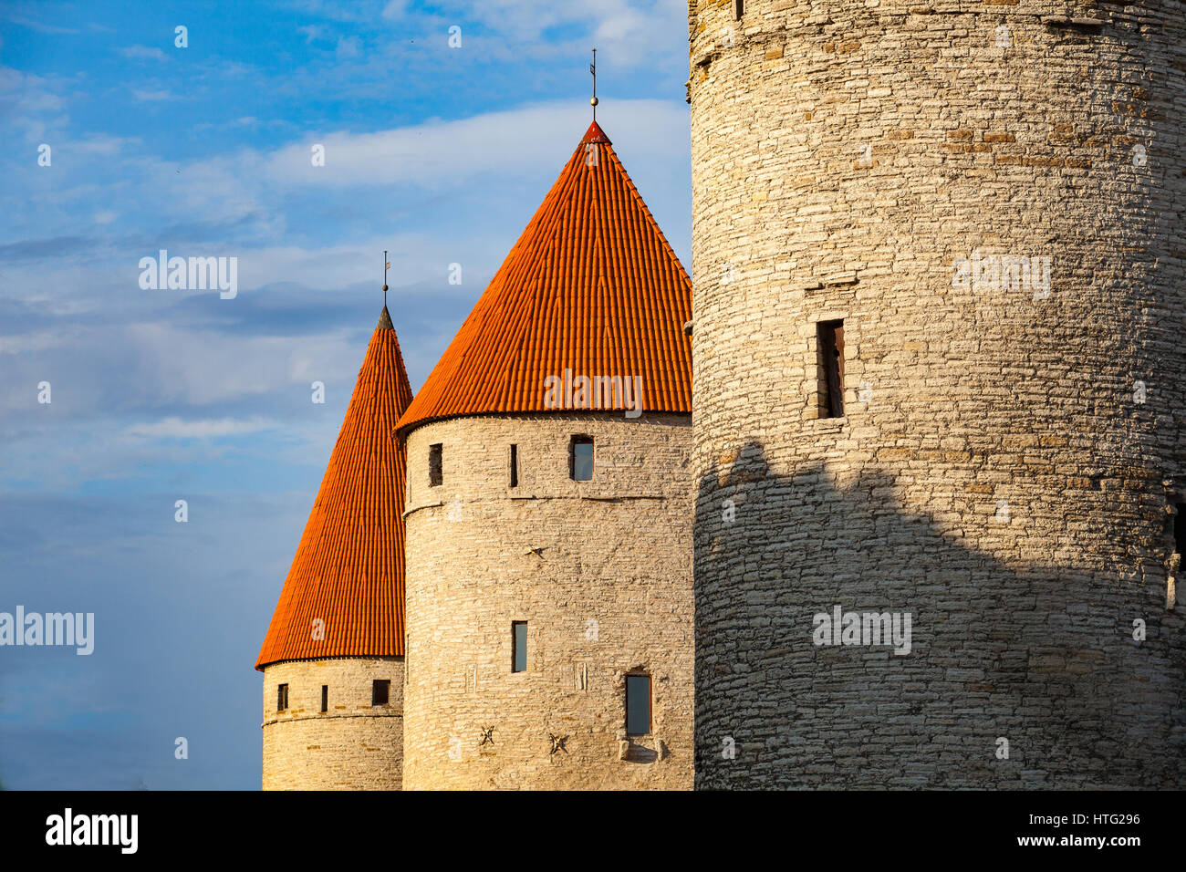 The medieval towers of old Tallinn, Estonia. Close up photo at sunset ...
