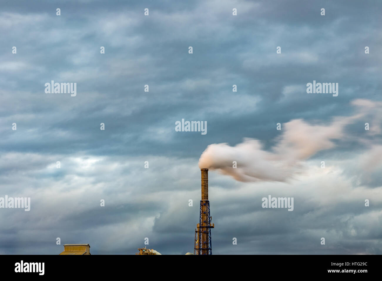 Smoke coming out of a steel smokestack Stock Photo - Alamy