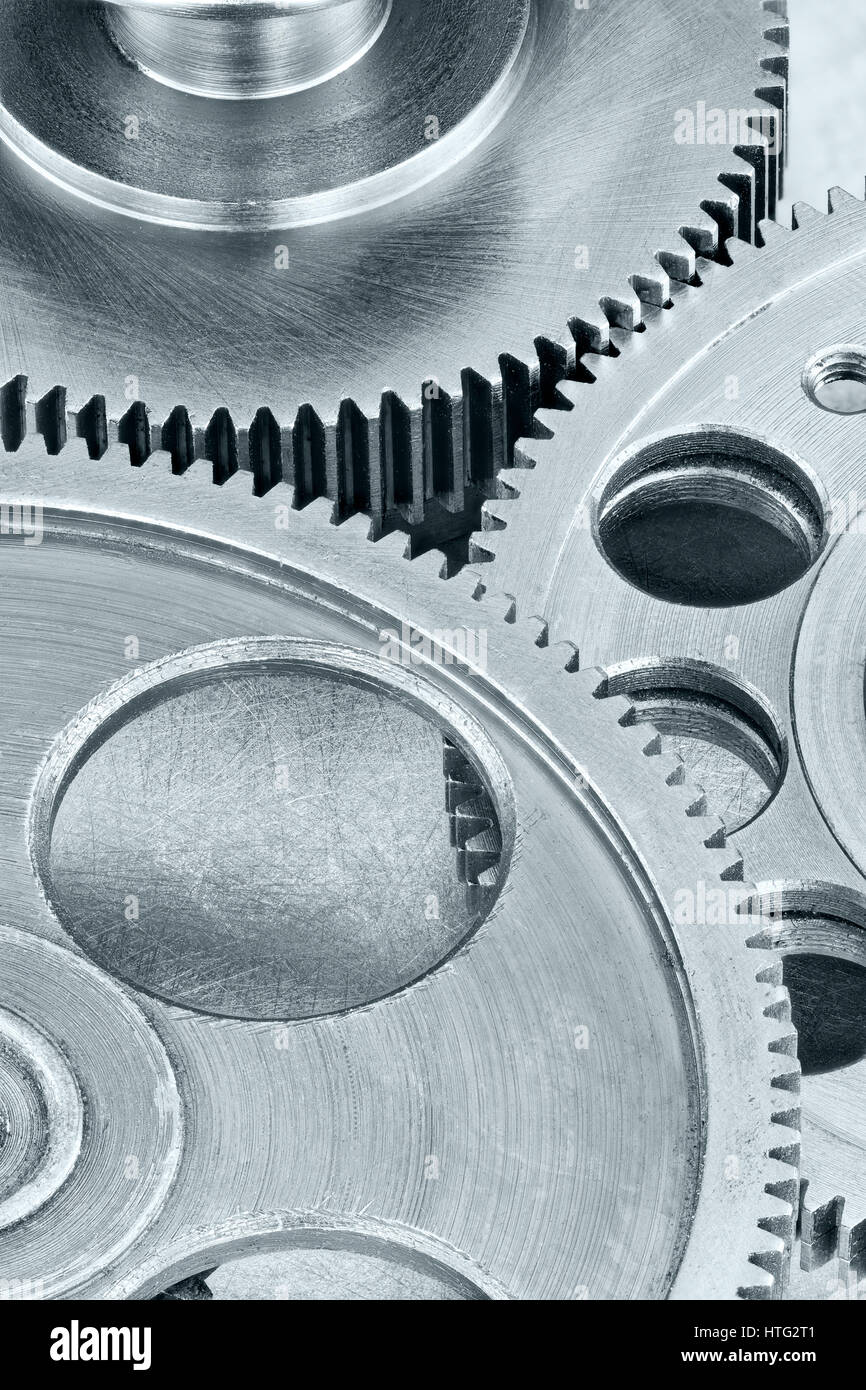 set of different industrial cogwheels on technology background closeup ...