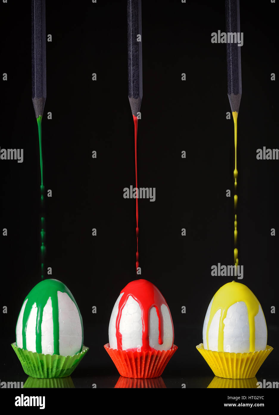 Abstract eggs and black pencils pouring colors Stock Photo - Alamy