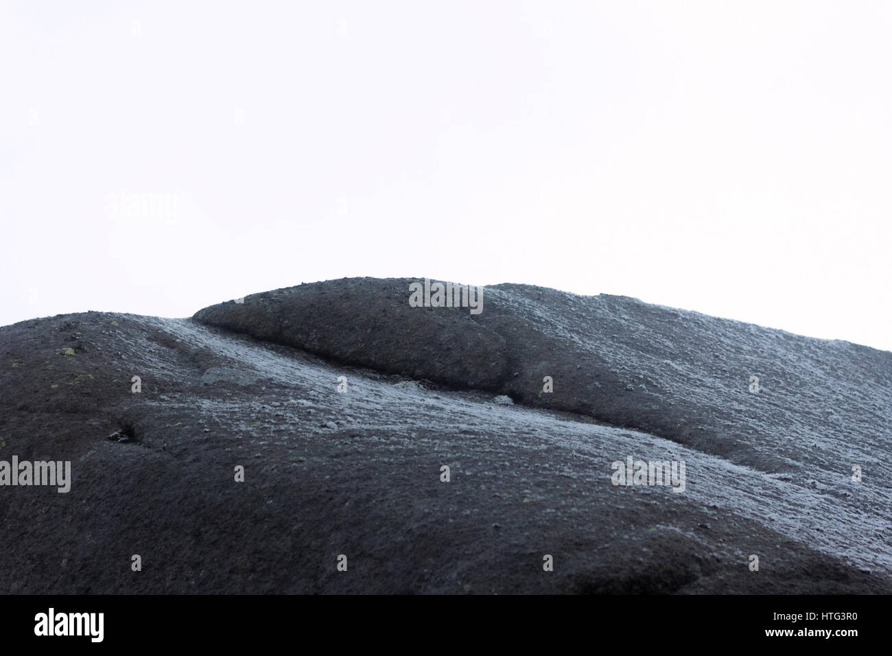 a rounded stone wet with ocean water Stock Photo - Alamy