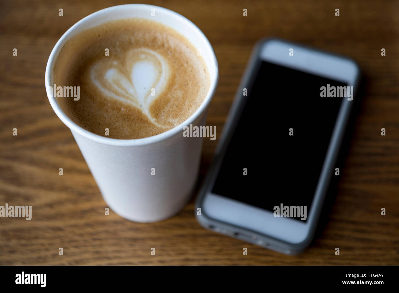 a cup of coffee and the phone Stock Photo - Alamy