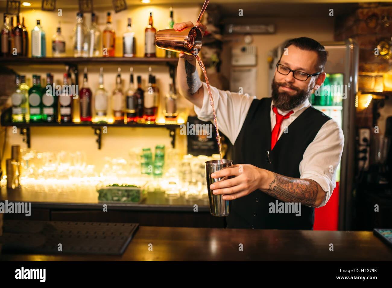 Barkeeper show behind restaurant bar counter. Handsome alcohol beverage ...