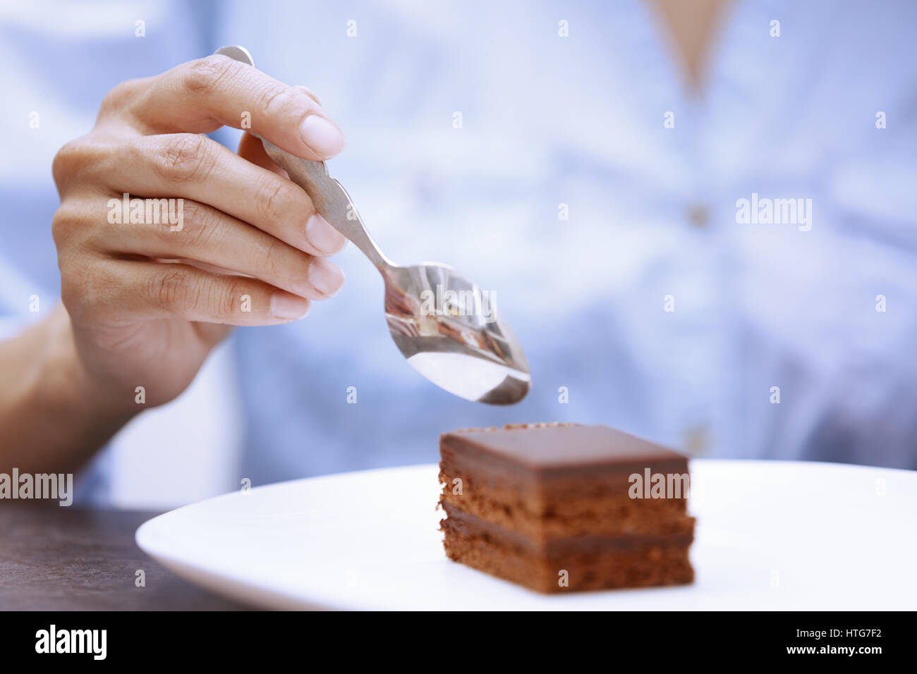 Hand of woman eating chocolate cake Stock Photo - Alamy