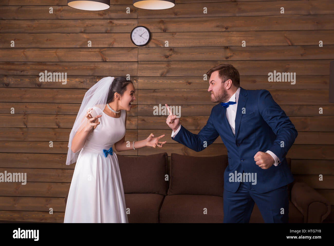 Bride and groom shouting at each other. Newlyweds complex relationship ...