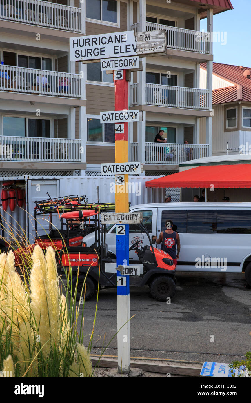 Post with signs marking water levels at various hurricane intensities ...