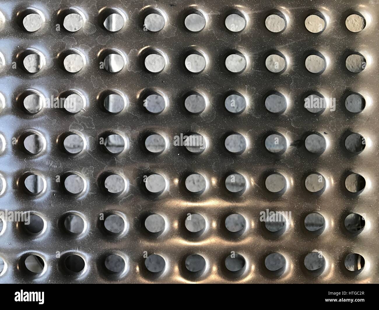 Steel plates with holes for texture. Background Stock Photo - Alamy