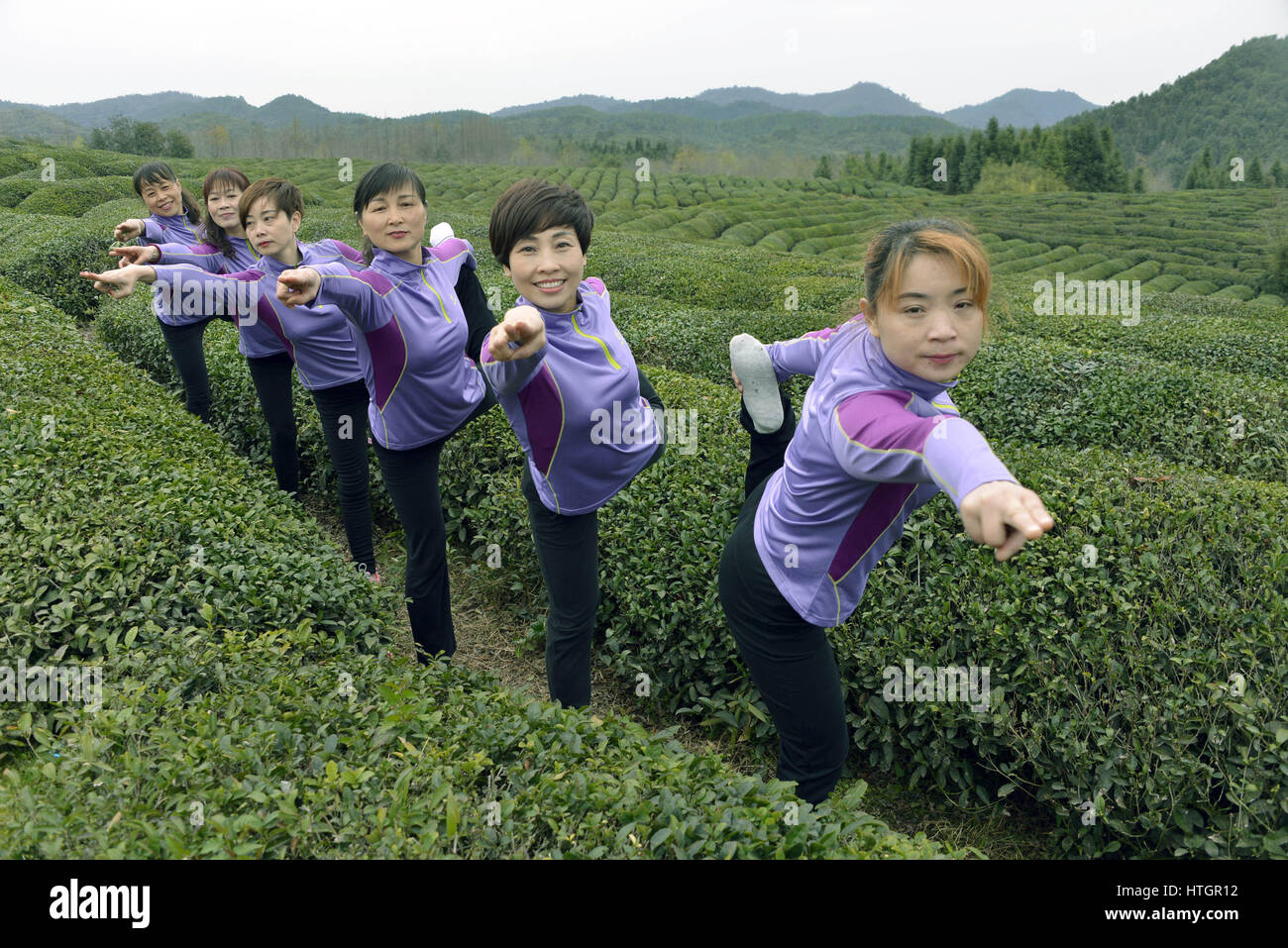 Dexing, Dexing, China. 15th Mar, 2017. Women practice yoga at the tea ...
