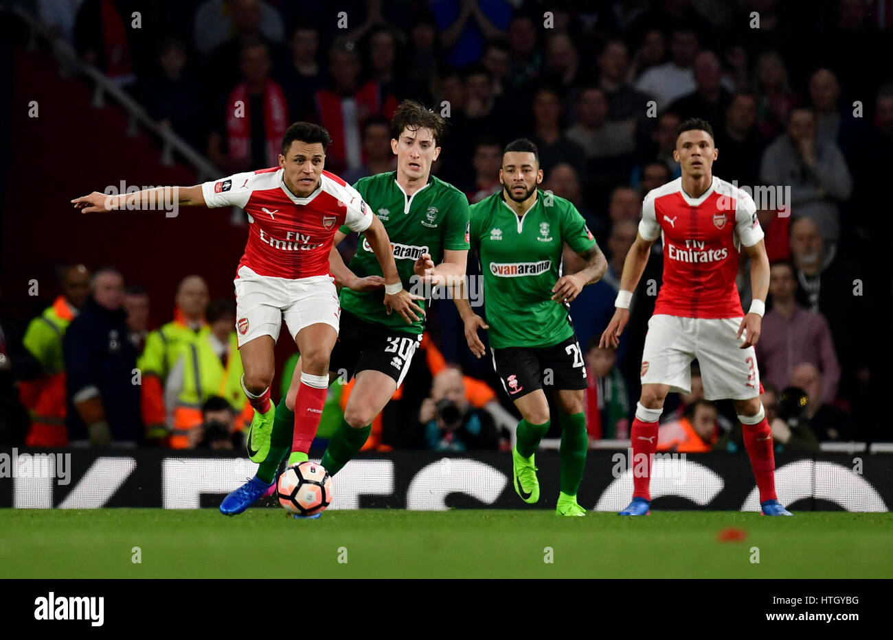(left-right) Arsenal's Alexis Sanchez , Lincoln City's Alex Woodyard ...