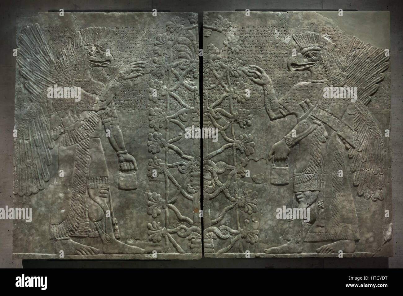 Assyrian Tree Of Life Being Pollinated By Two Winged Genies Through Means Of Pine Cones