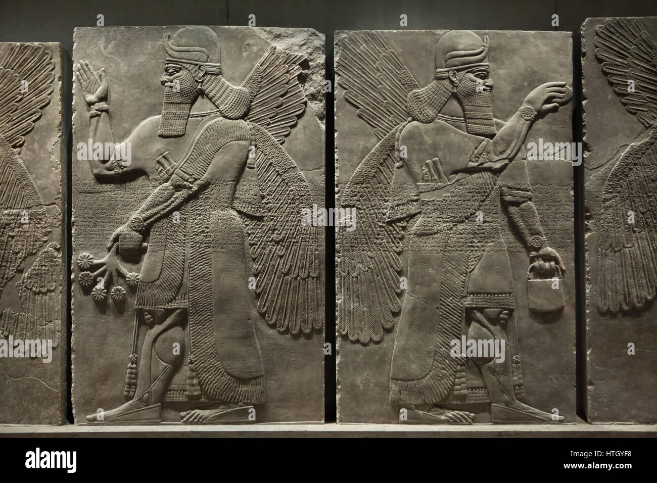 Assyrian winged genies. Assyrian relief from the Northwest Palace of ...