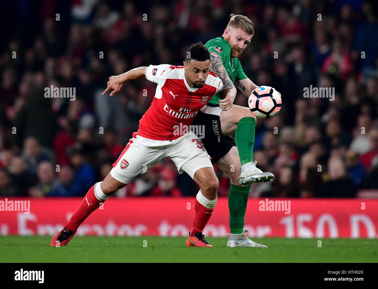Arsenal's Francis Coquelin (left) and Lincoln City's Alan Power during ...
