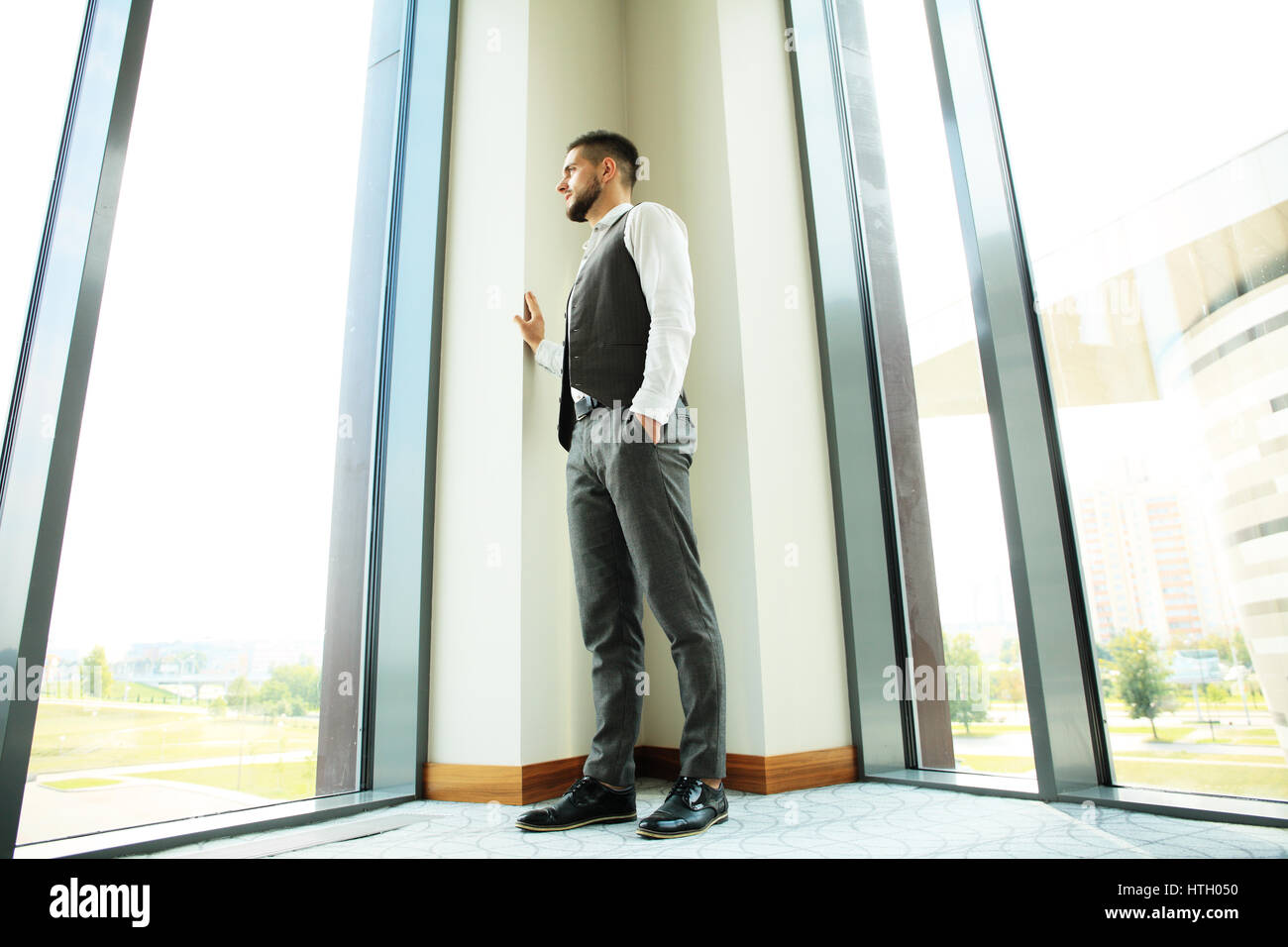 Portrait of a businessman looking at the window Stock Photo - Alamy