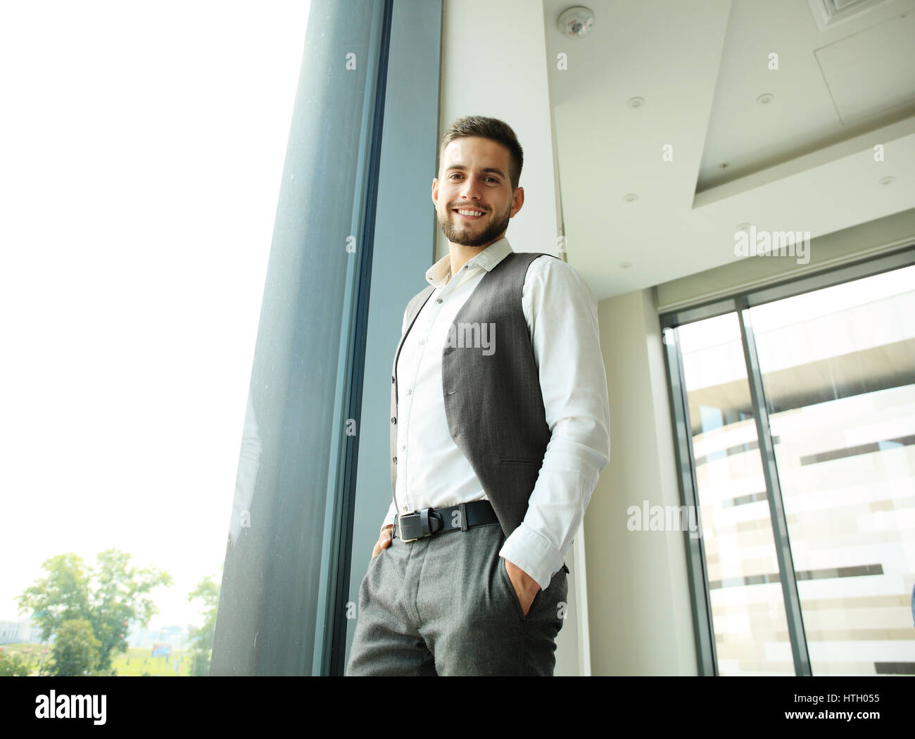 Portrait of a businessman looking at the window Stock Photo - Alamy