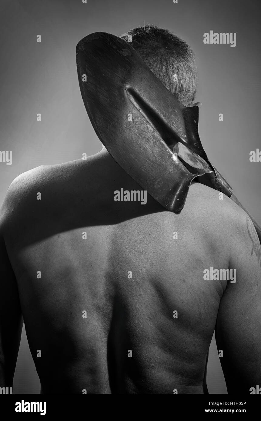 A man with a shovel on his shoulder Stock Photo - Alamy