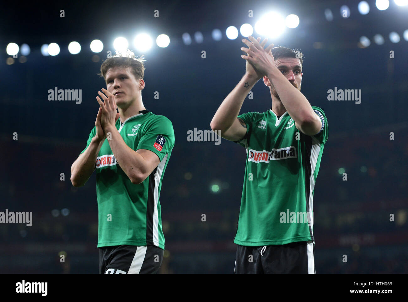 Lincoln City's Sean Raggett and Luke Waterfall applaud the fans after ...