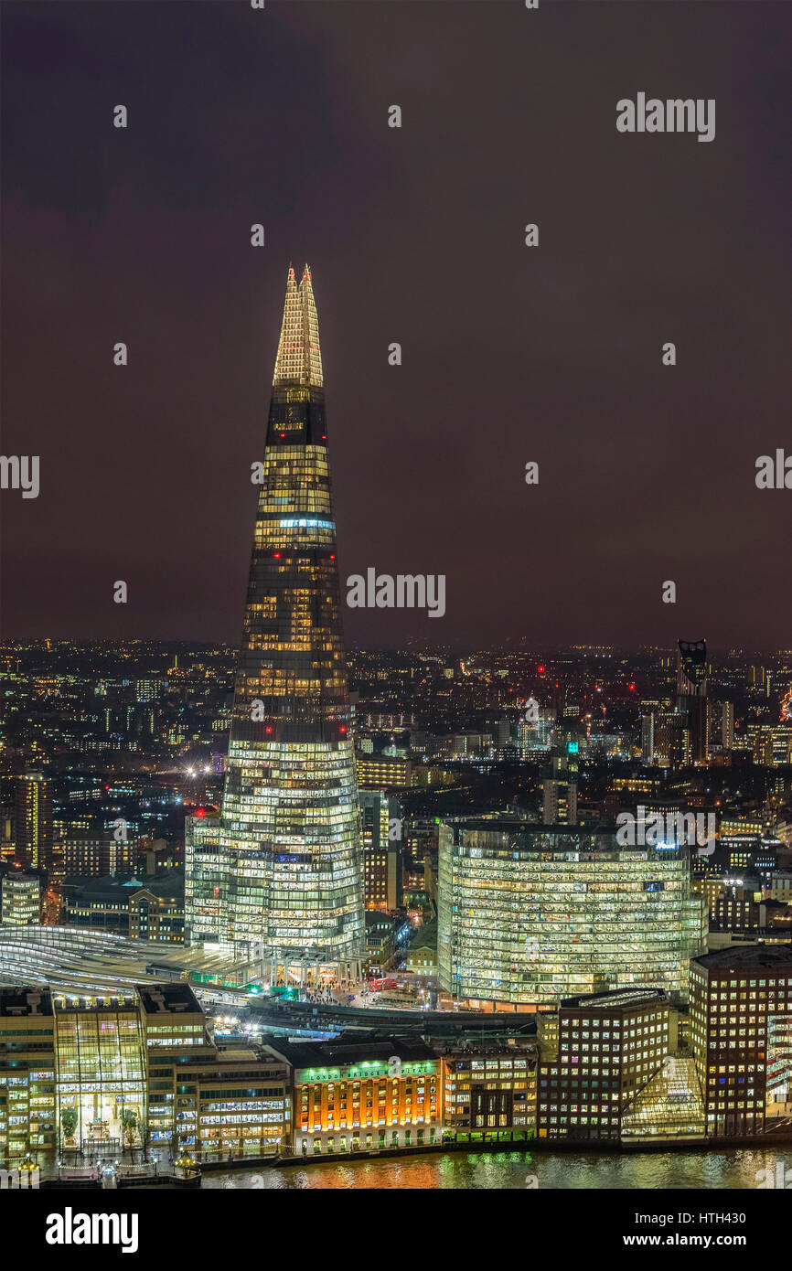 Night scene of urban London with the Shard skyscraper and Thames river ...