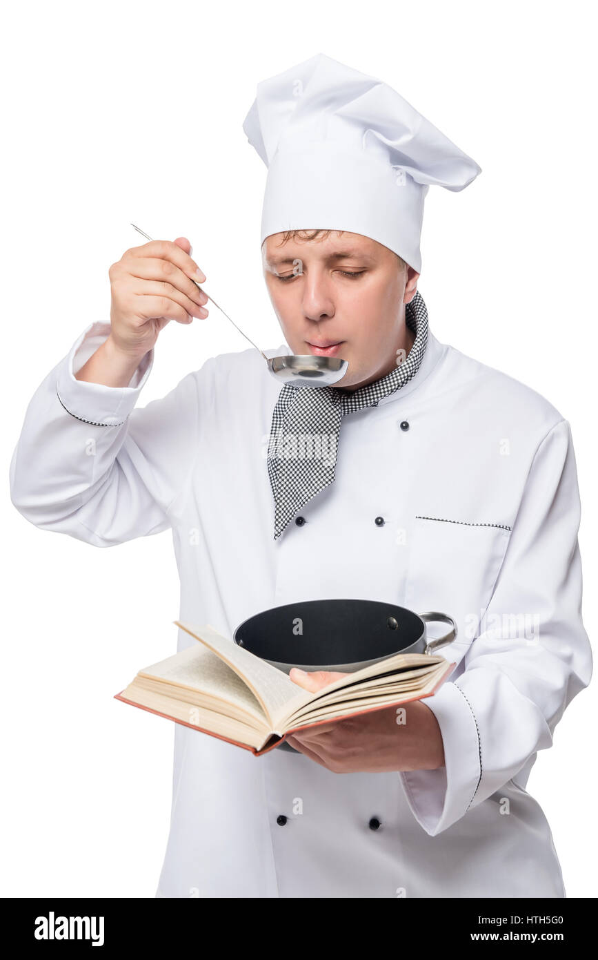 chef tastes the soup and reading a recipe book on a white background ...