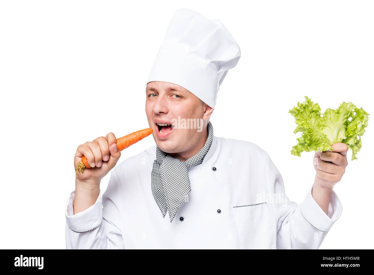 chef eating fresh carrot in studio against a white background Stock ...