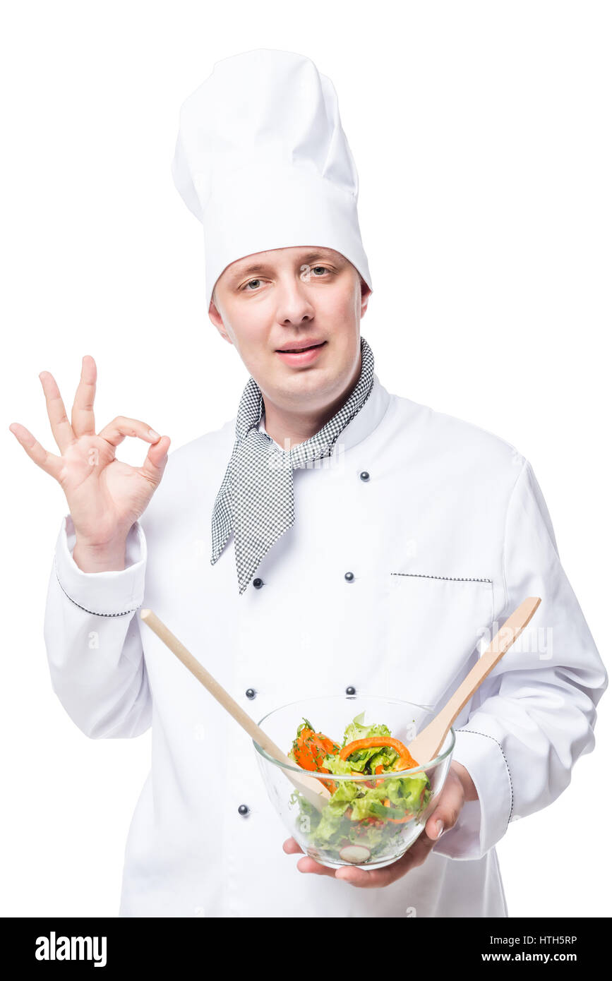 portrait of admiring chef with salad in hands showing hand gesture on a ...