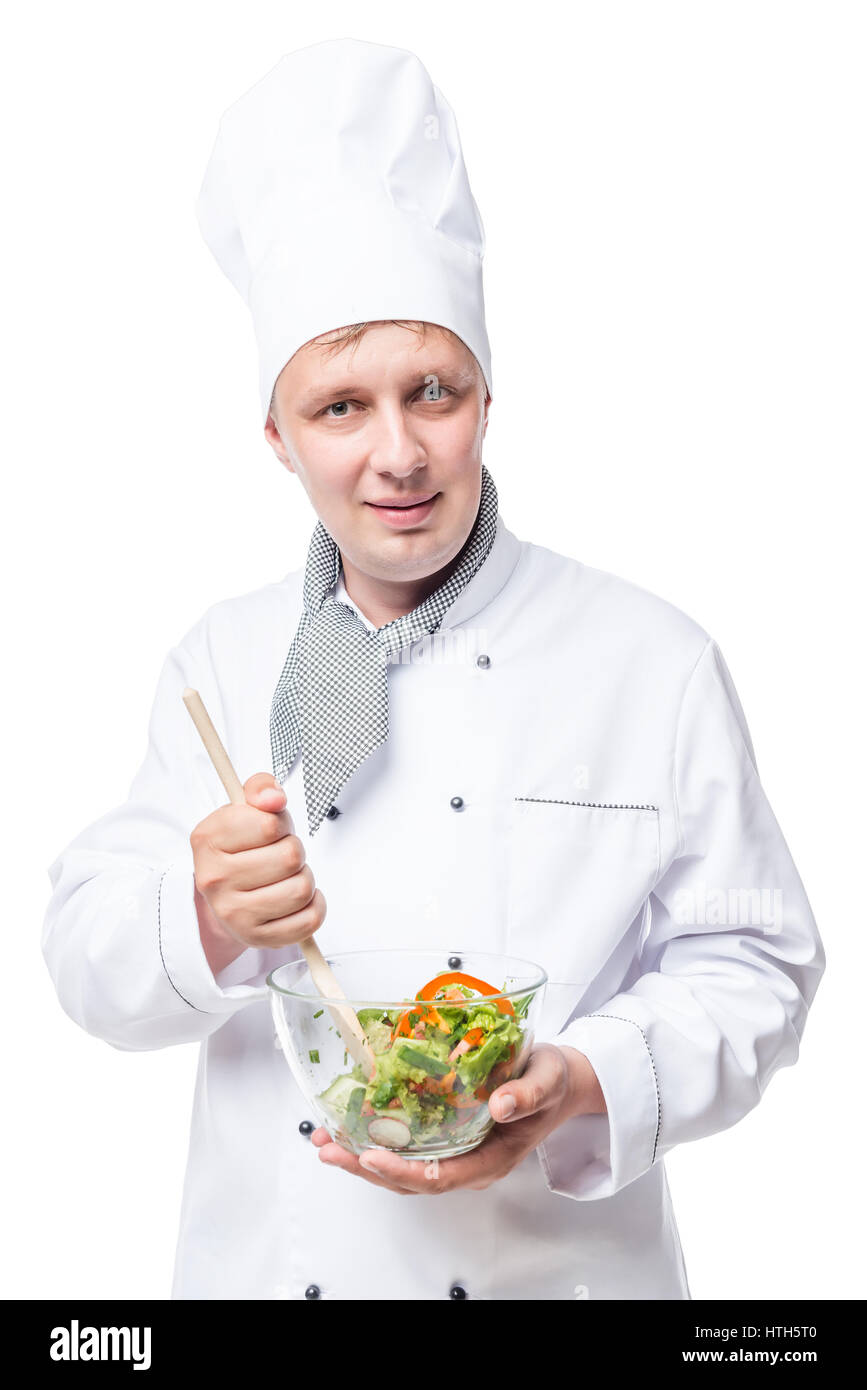 professional chef mixing vegetable salad in a bowl on a white ...