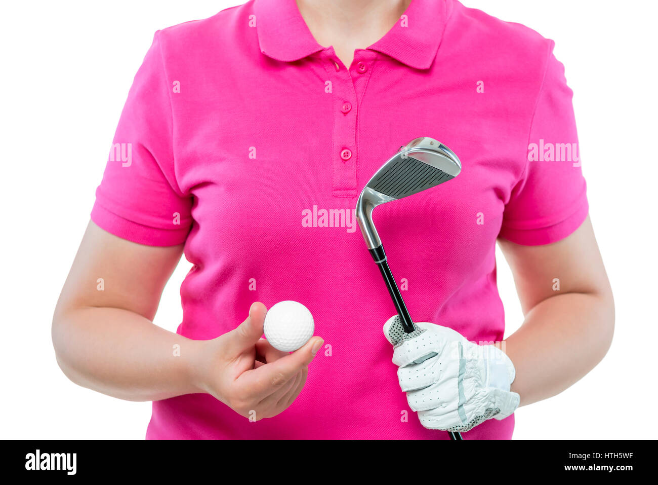 close-up hands of a golfer with a ball and a club in the studio on a ...