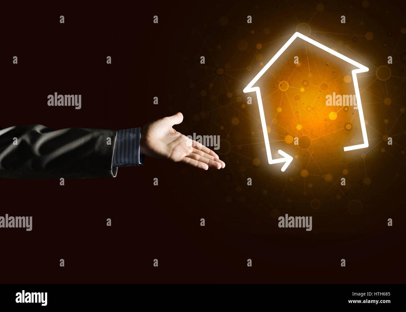 Businessman hand pointing to the glowing home icon or symbol Stock ...
